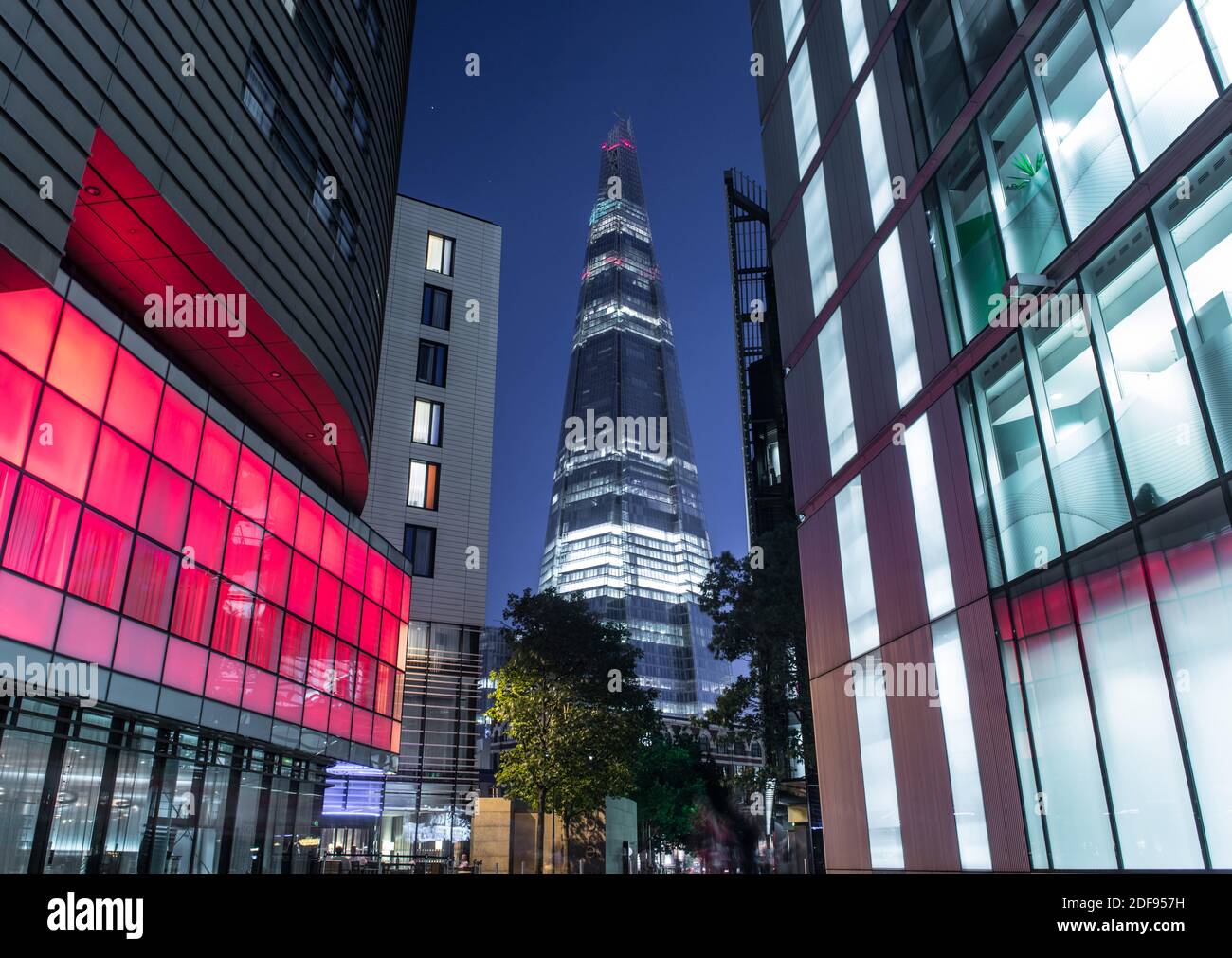 Mixed use retail and offices at dusk with the Shard at London Bridge ...