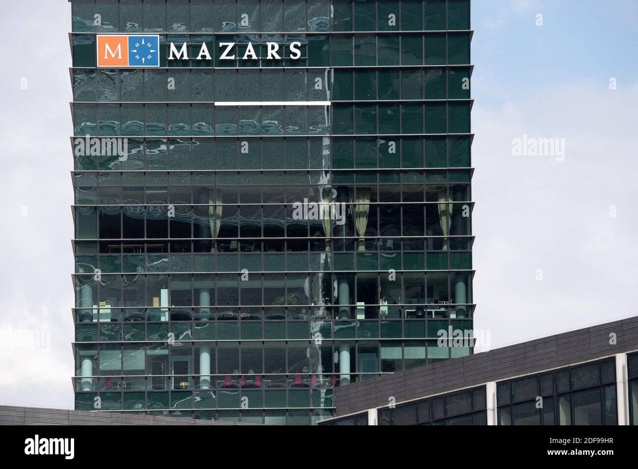 A shop sign of Mazars in the defense district in Paris, on April 17 ...