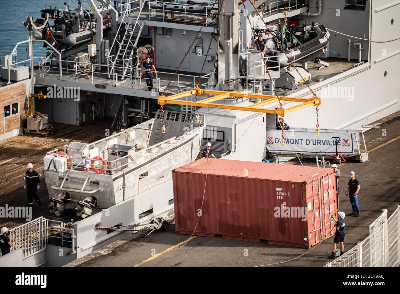 Hand out photo of French Navy sailors unload containers from the ...
