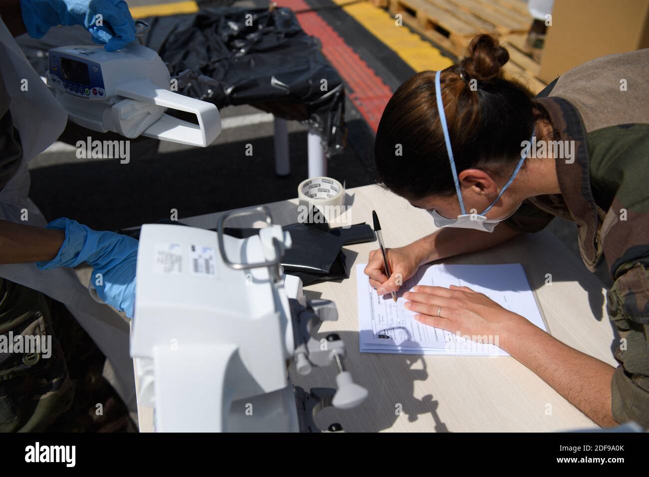 Hand out photo of The military field hospital set up in the parking lot ...
