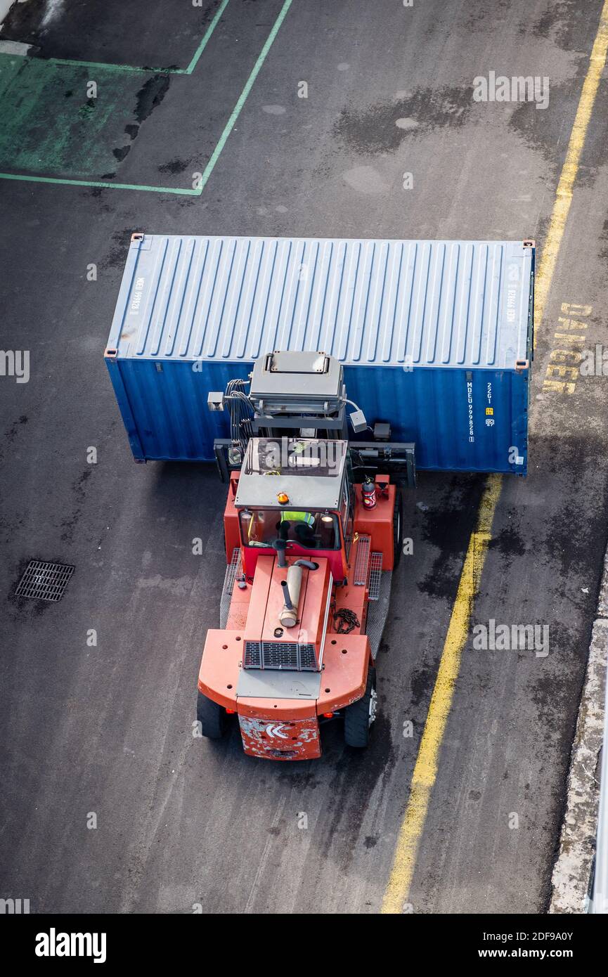 Hand out photo of French Navy sailors unload containers from the ...