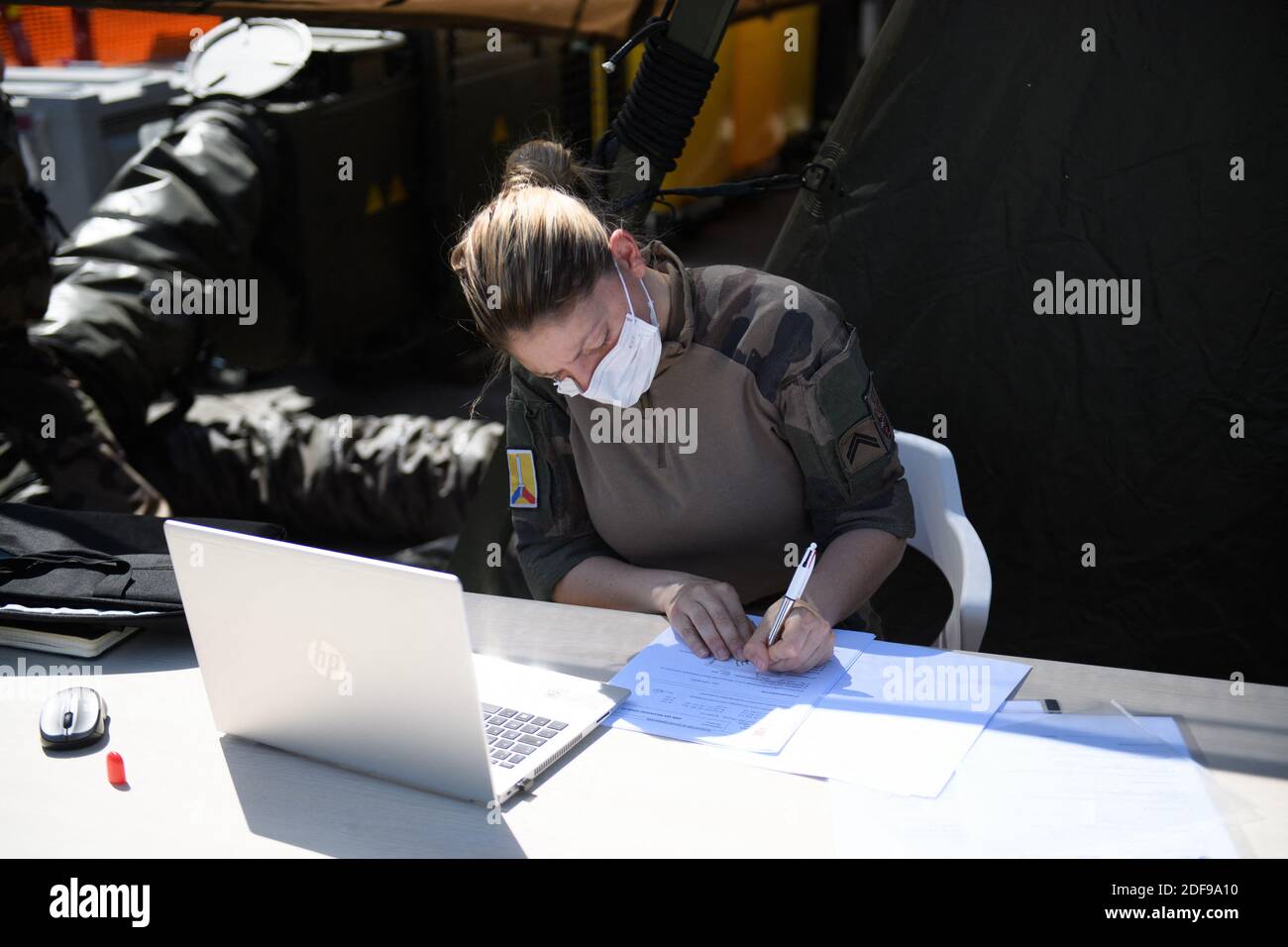 Hand out photo of The military field hospital set up in the parking lot ...