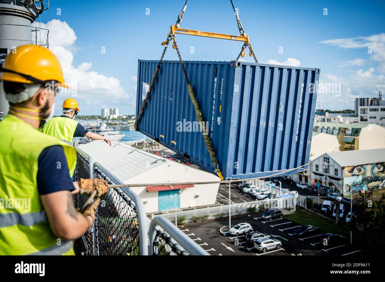 Hand out photo of French Navy sailors unload containers from the ...