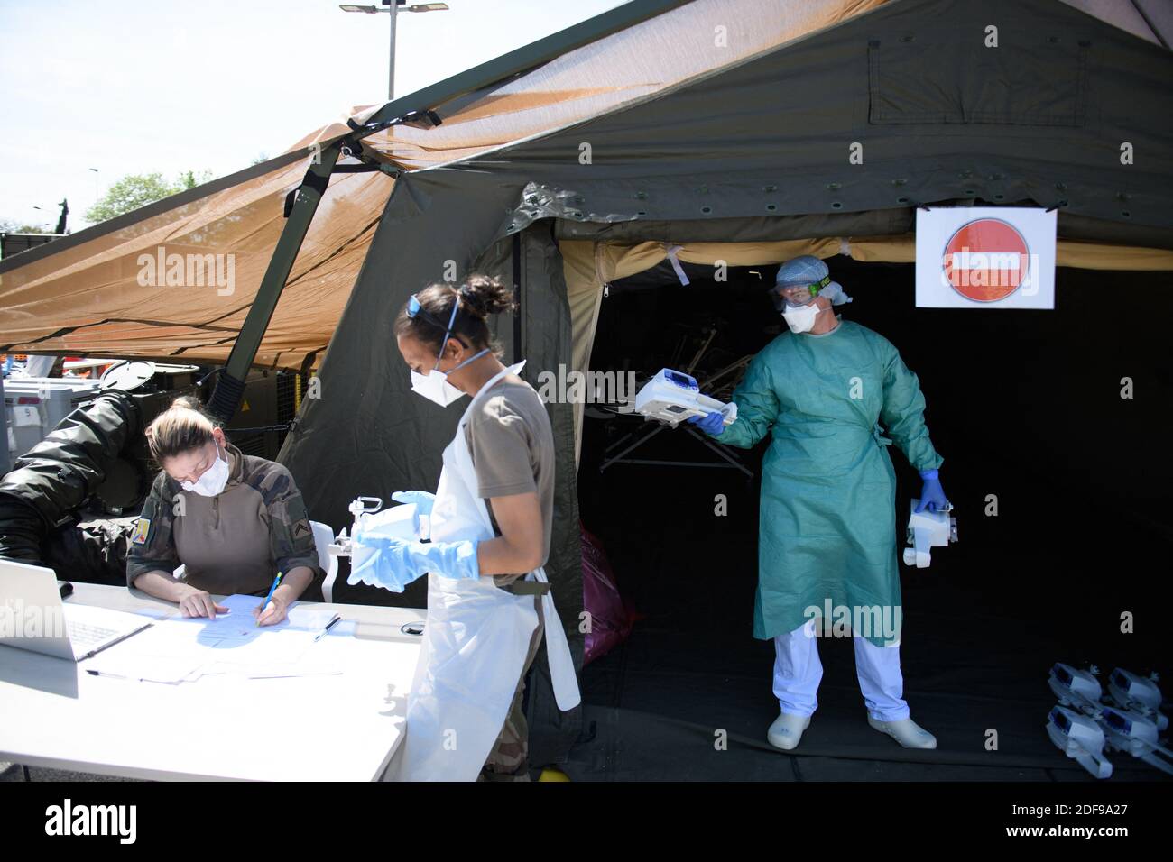 Hand out photo of The military field hospital set up in the parking lot ...