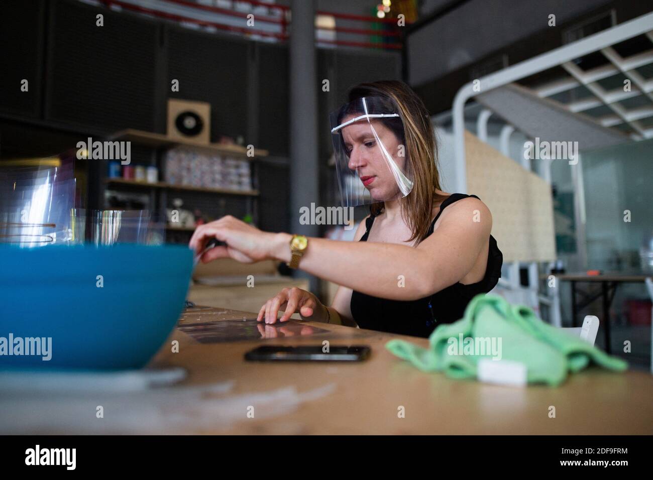 Volunteers wearing face visor of the Villette Makers fab lab makes face visor for the hospitals ...