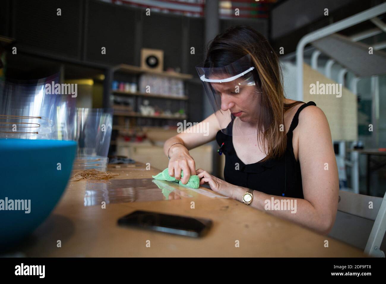 Volunteers wearing face visor of the Villette Makers fab lab makes face visor for the hospitals ...