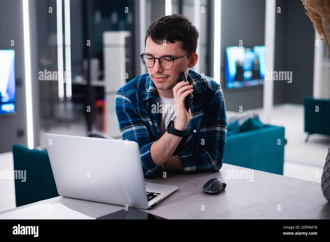 View of concentrated talented skilled male focused on screen of laptop ...