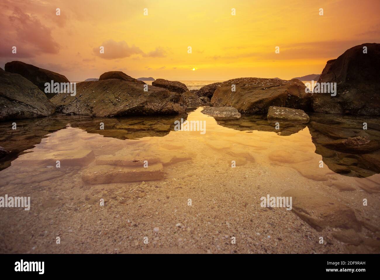 Rocks at a beach during sunset Stock Photo - Alamy