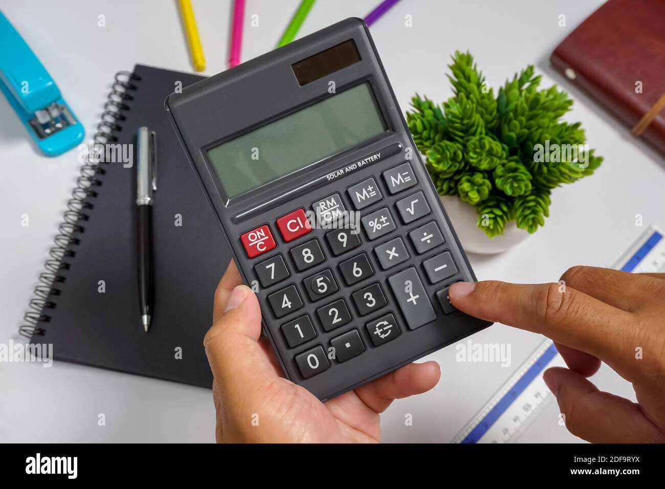 Hands holding a calculator on top of office working table Stock Photo ...