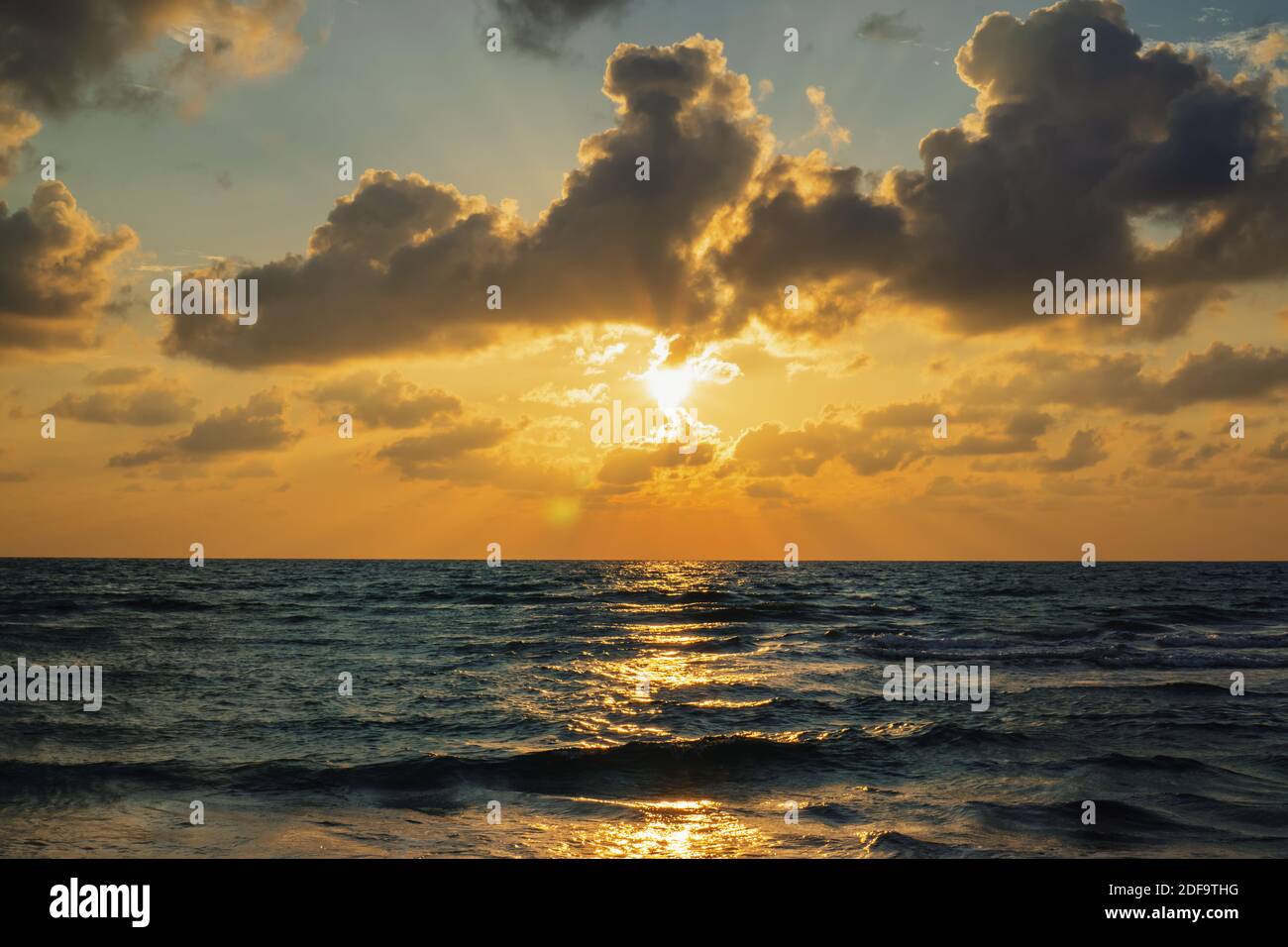 Sunbeam through cloud formation on ocean horizon during sunset Stock ... Sunbeam through cloud formation on ocean horizon during sunset Stock ...