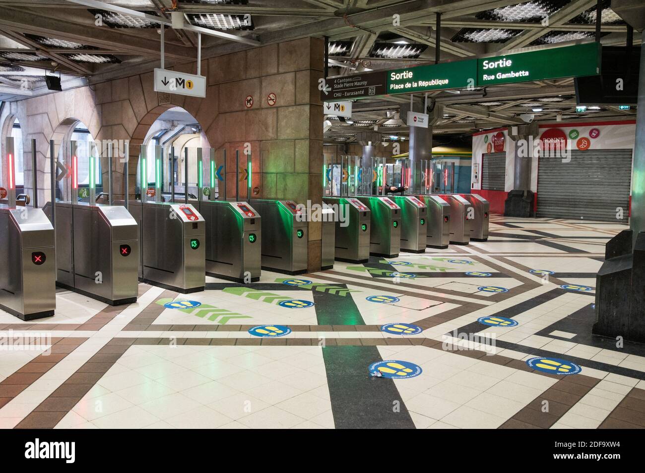 Signs are pictured on the floor of Republique's subway station to mark ...