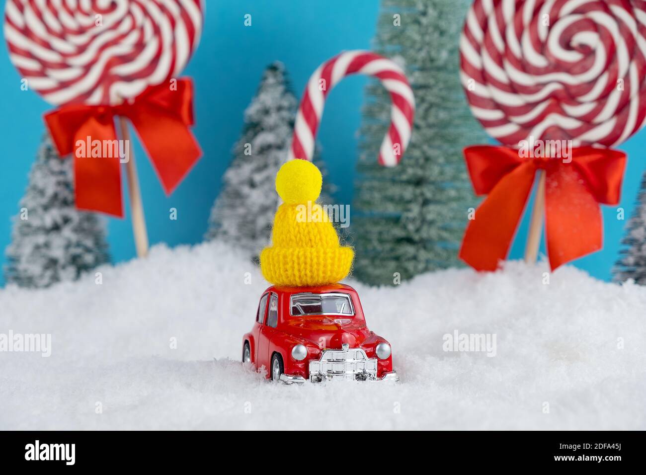 Red Santa car with in yellow winter cap and Christmas tree forest with ...