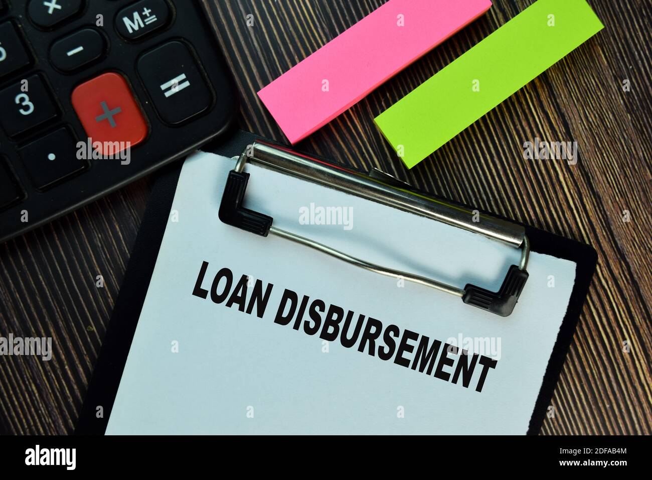 Loan Disbursement write on a paperwork isolated on Wooden Table ...