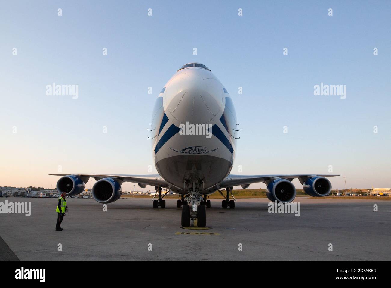 Employees of the business by air company unload a face mask supply ...