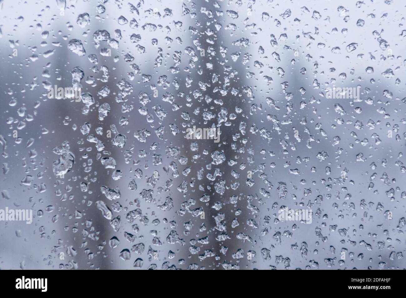 Melting snow on the glass, drops of water condensation on the window ...