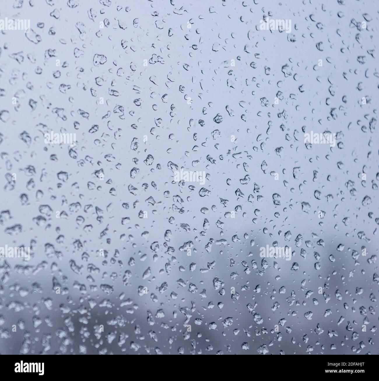 Melting snow on the glass, drops of water condensation on the window ...