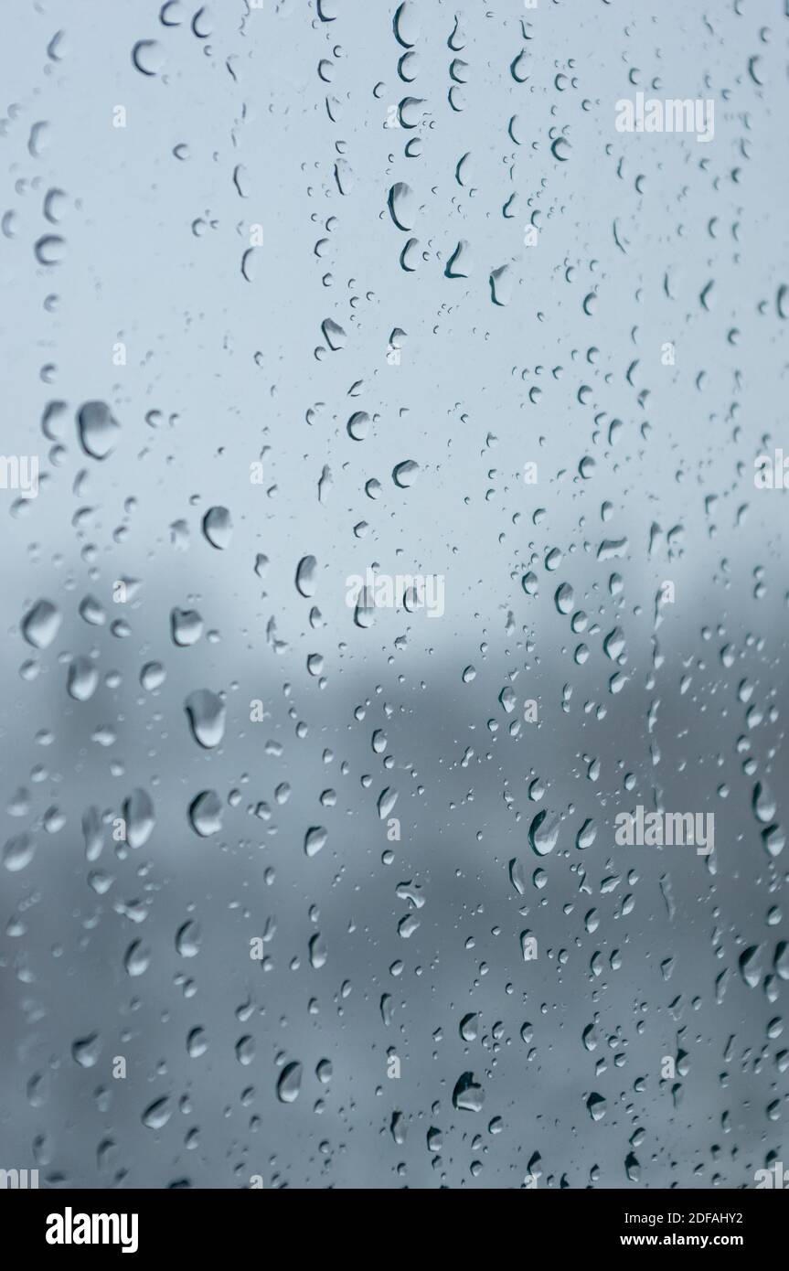 Melting snow on the glass, drops of water condensation on the window ...