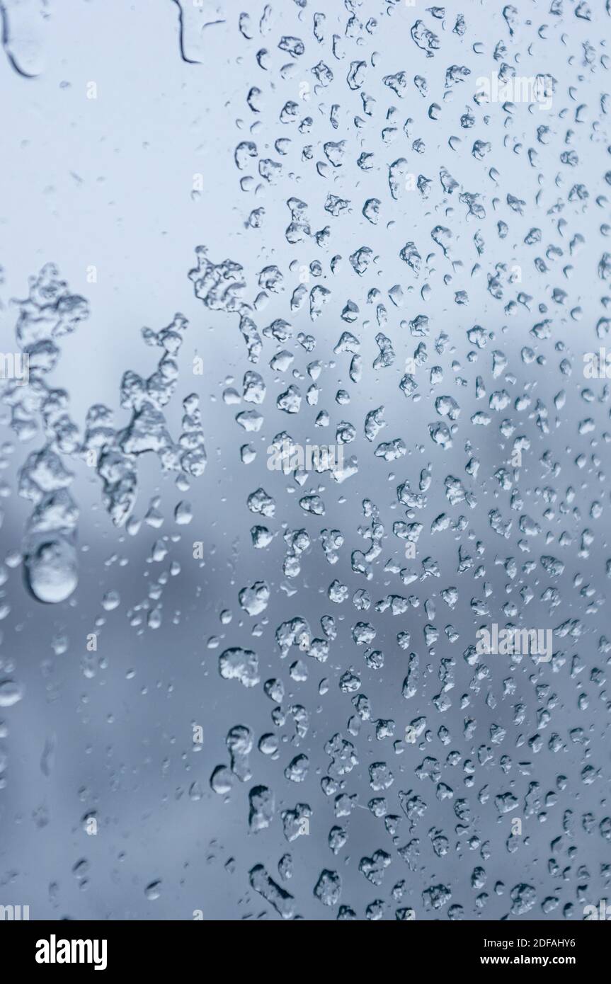 Melting snow on the glass, drops of water condensation on the window ...