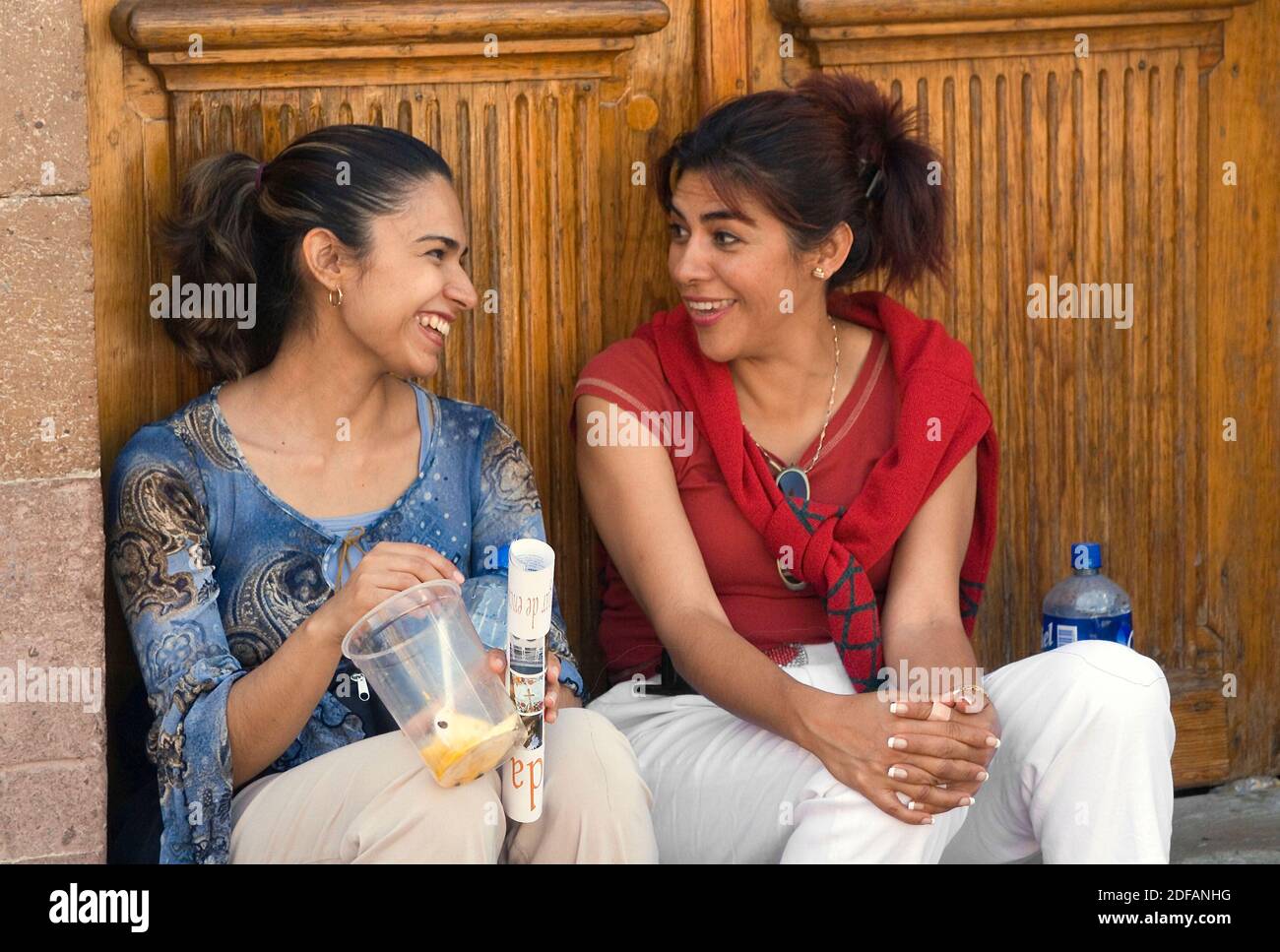 Young MEXICAN WOMEN enjoy a laugh in the historic town of GUANAJUATO ...