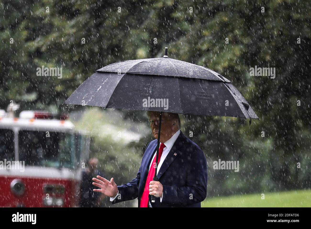 President Donald Trump walks on the South Lawn of the White House in a ...