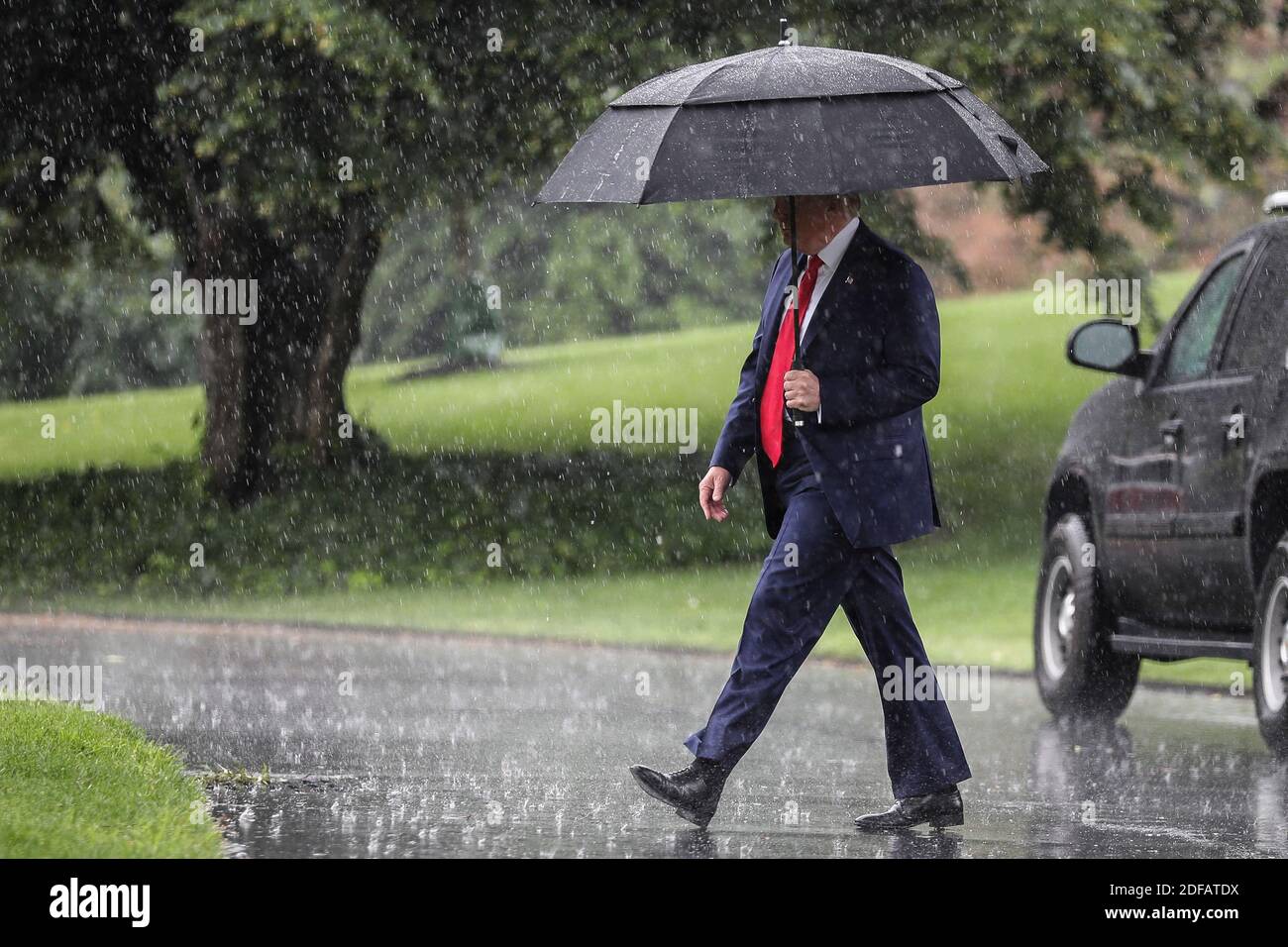 President Donald Trump walks on the South Lawn of the White House in a ...