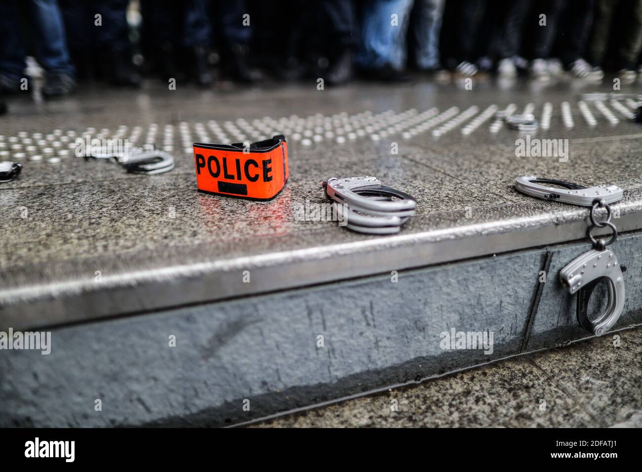 Police demonstrate by putting their handcuffs on the ground at the ...