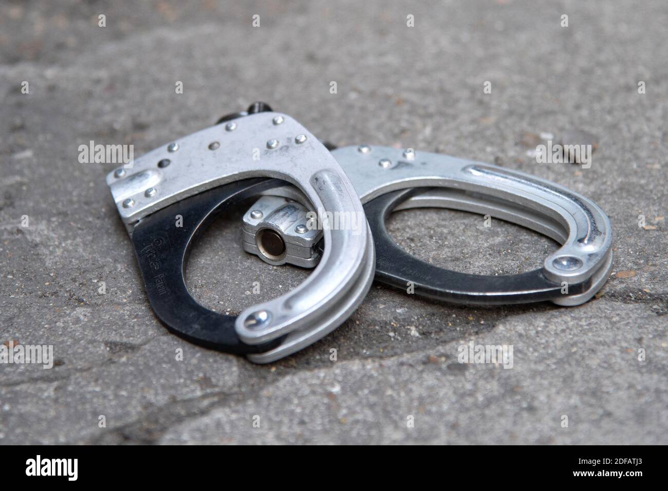 Police officers demonstrate by putting their handcuffs on the ground at ...