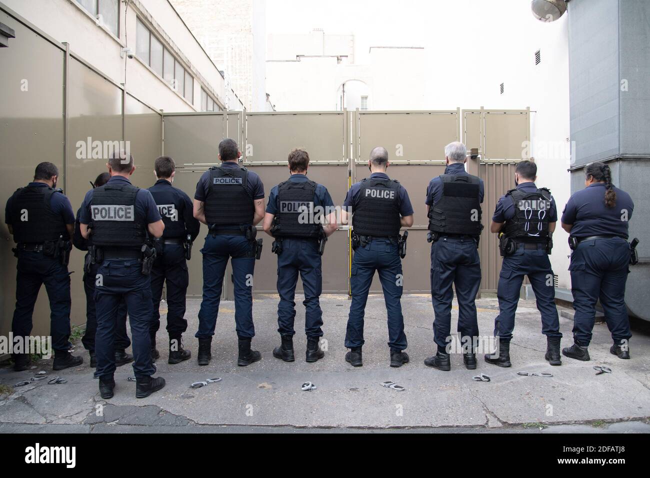 Police officers demonstrate by putting their handcuffs on the ground at ...
