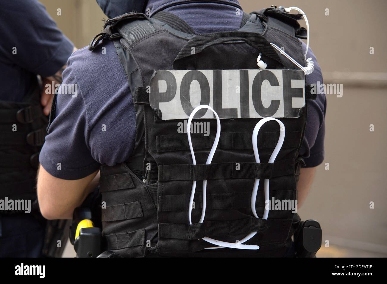 Police officers demonstrate by putting their handcuffs on the ground at ...