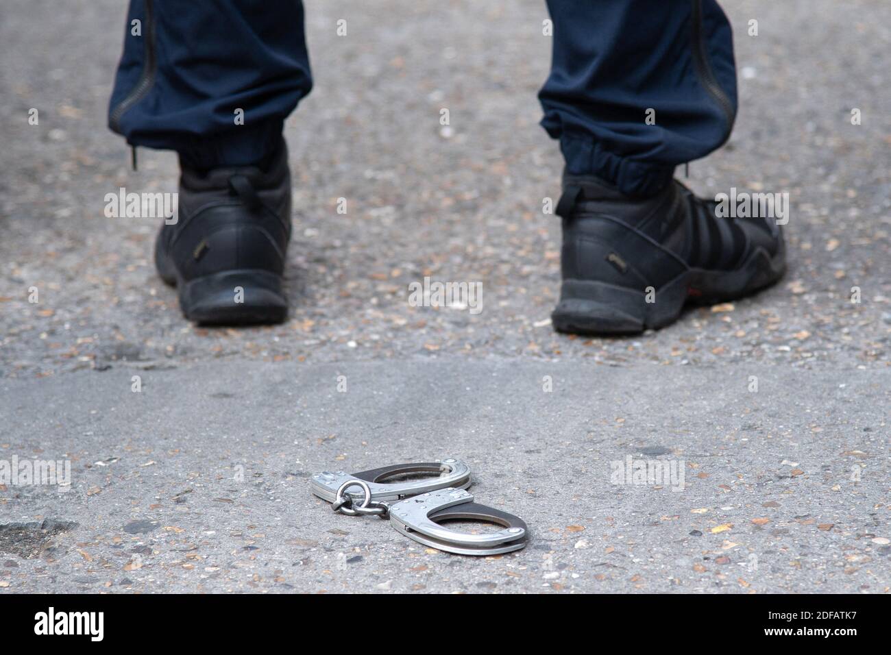 Police officers demonstrate by putting their handcuffs on the ground at ...