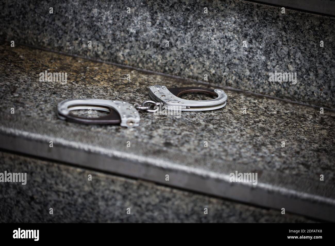 Police demonstrate by putting their handcuffs on the ground at the ...