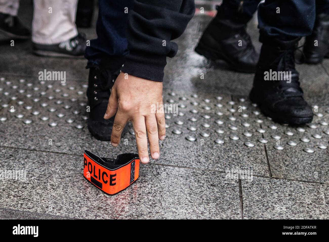 Police demonstrate by putting their handcuffs on the ground at the ...