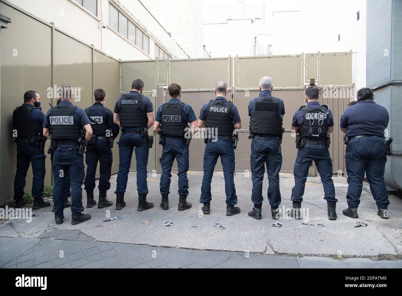 Police officers demonstrate by putting their handcuffs on the ground at ...