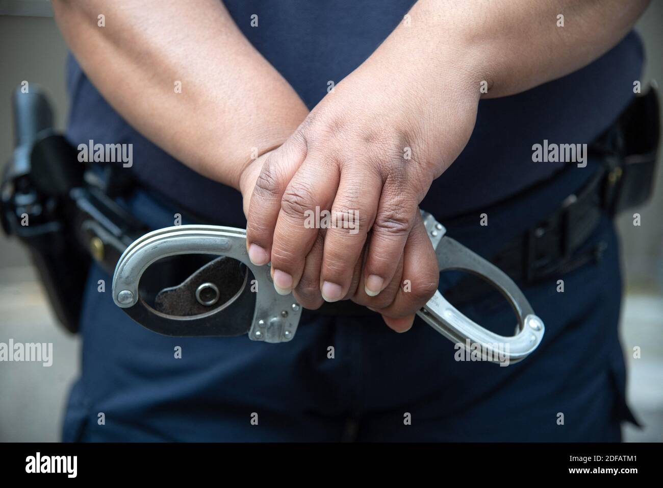 Police officers demonstrate by putting their handcuffs on the ground at ...