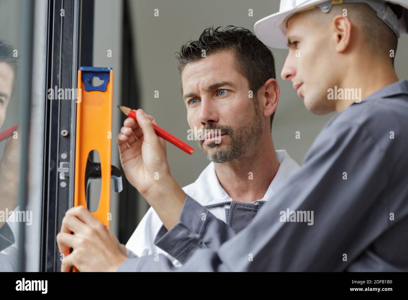 happy smiling constructor holding tool Stock Photo - Alamy