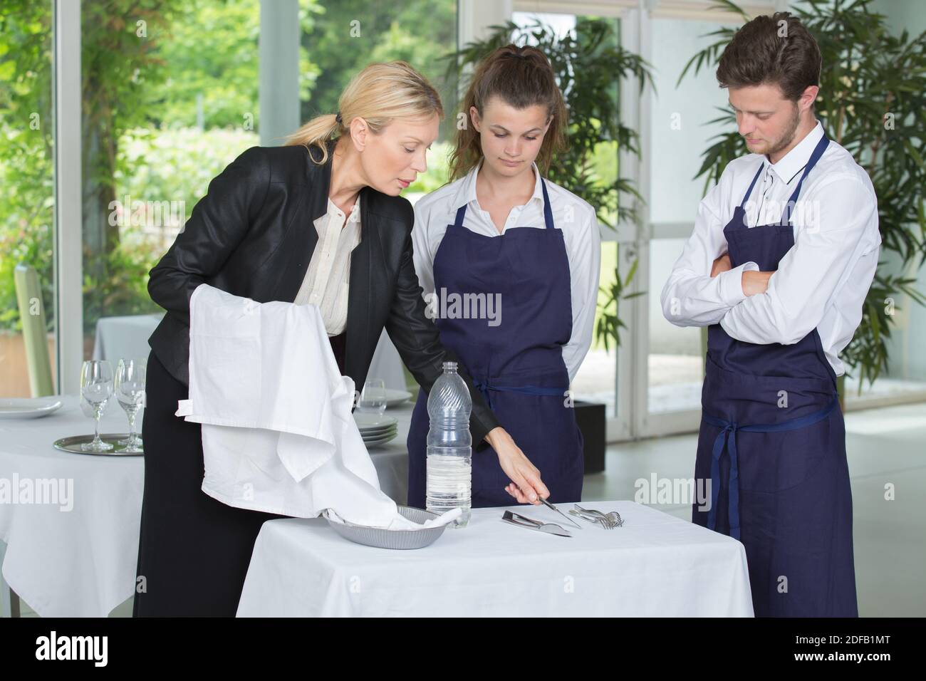 team setting up tables in luxury restaurant Stock Photo - Alamy