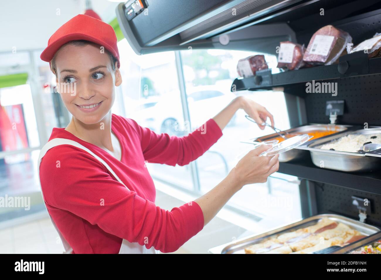 buffet female worker servicing food in cafeteria Stock Photo - Alamy