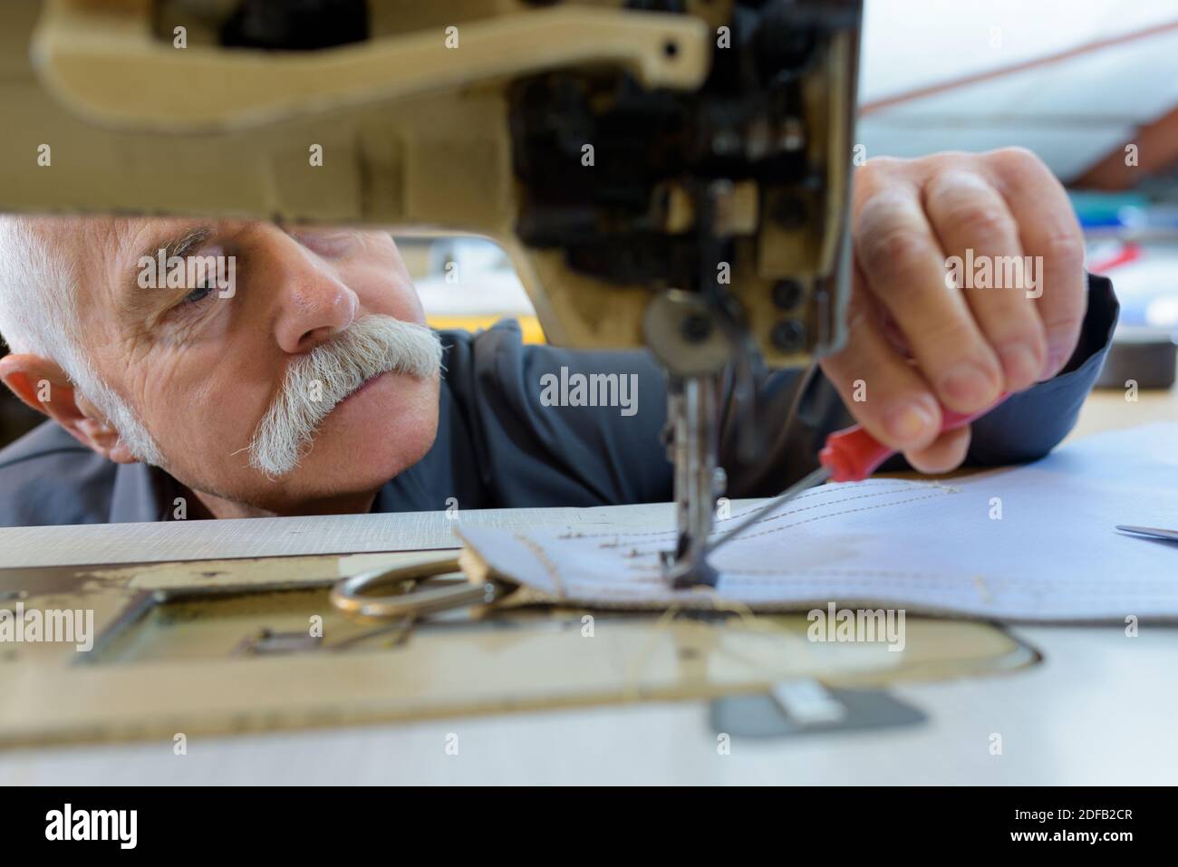 senior man working with old-sewing machine Stock Photo - Alamy