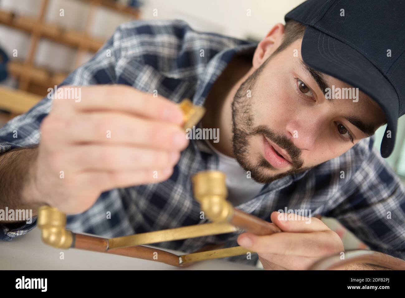 metallurgic young worker using copper pipes and fittings Stock Photo ...
