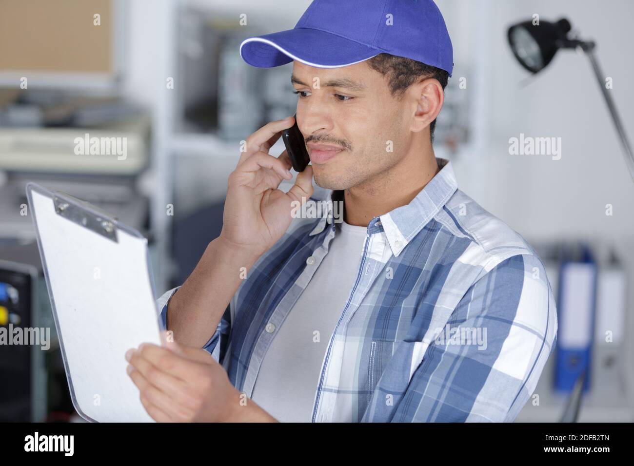 technician on phone at warehouse Stock Photo - Alamy