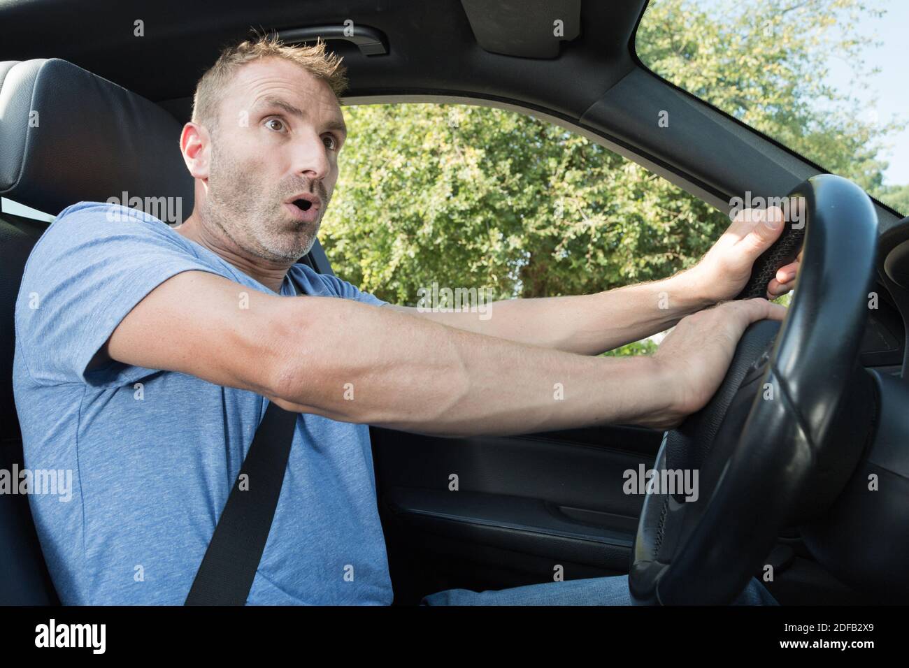 man driving a car with hand on horn button Stock Photo - Alamy