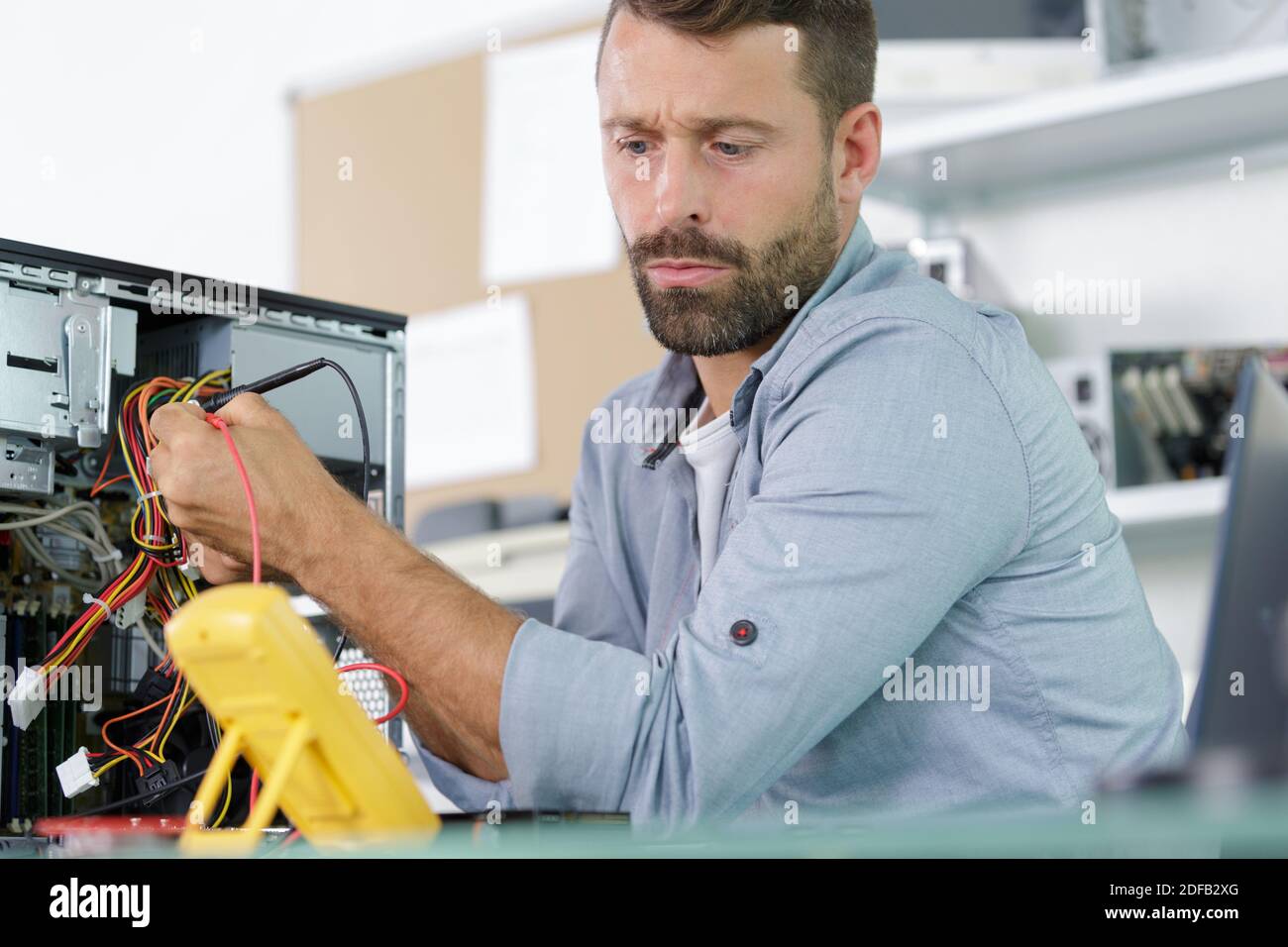 technician using voltage meter for voltage to fix a pc Stock Photo - Alamy