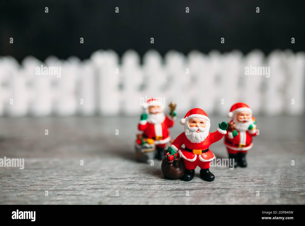 Black background. A white picket fence. Toy Santa Claus Stock Photo - Alamy