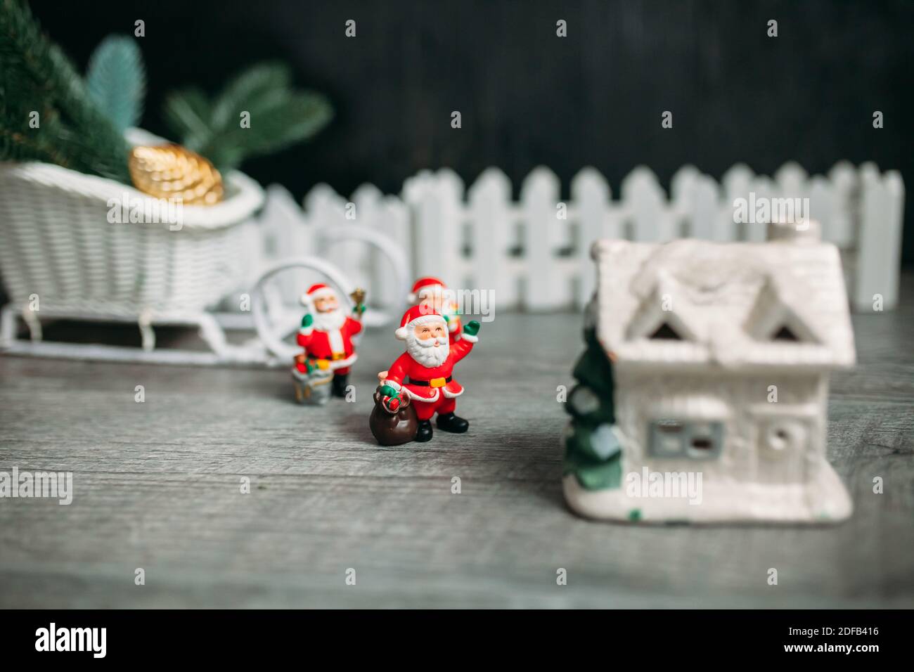 Black background. A white picket fence. Toy Santa Claus Stock Photo - Alamy