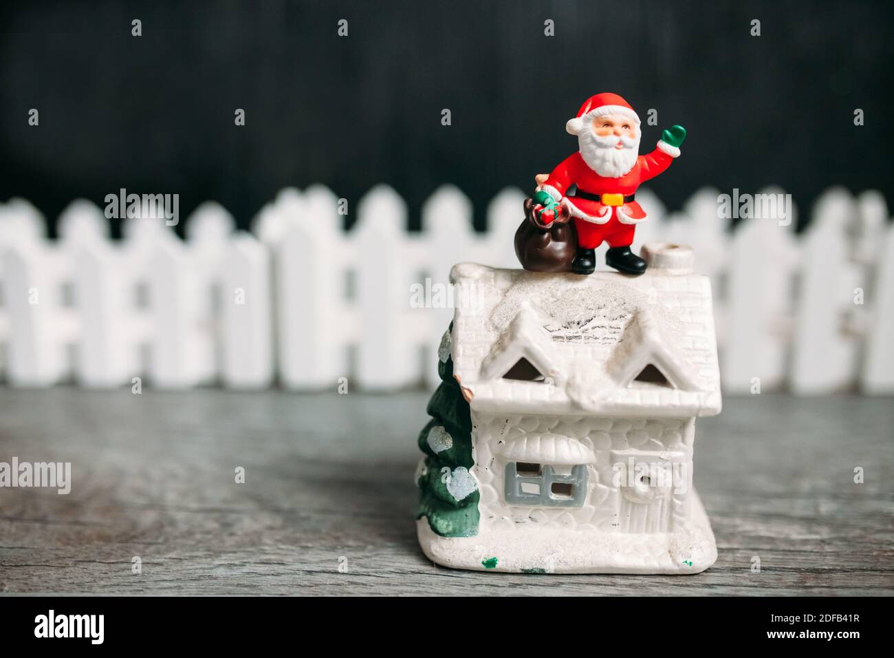 Black background. A white picket fence. Toy Santa Claus Stock Photo - Alamy