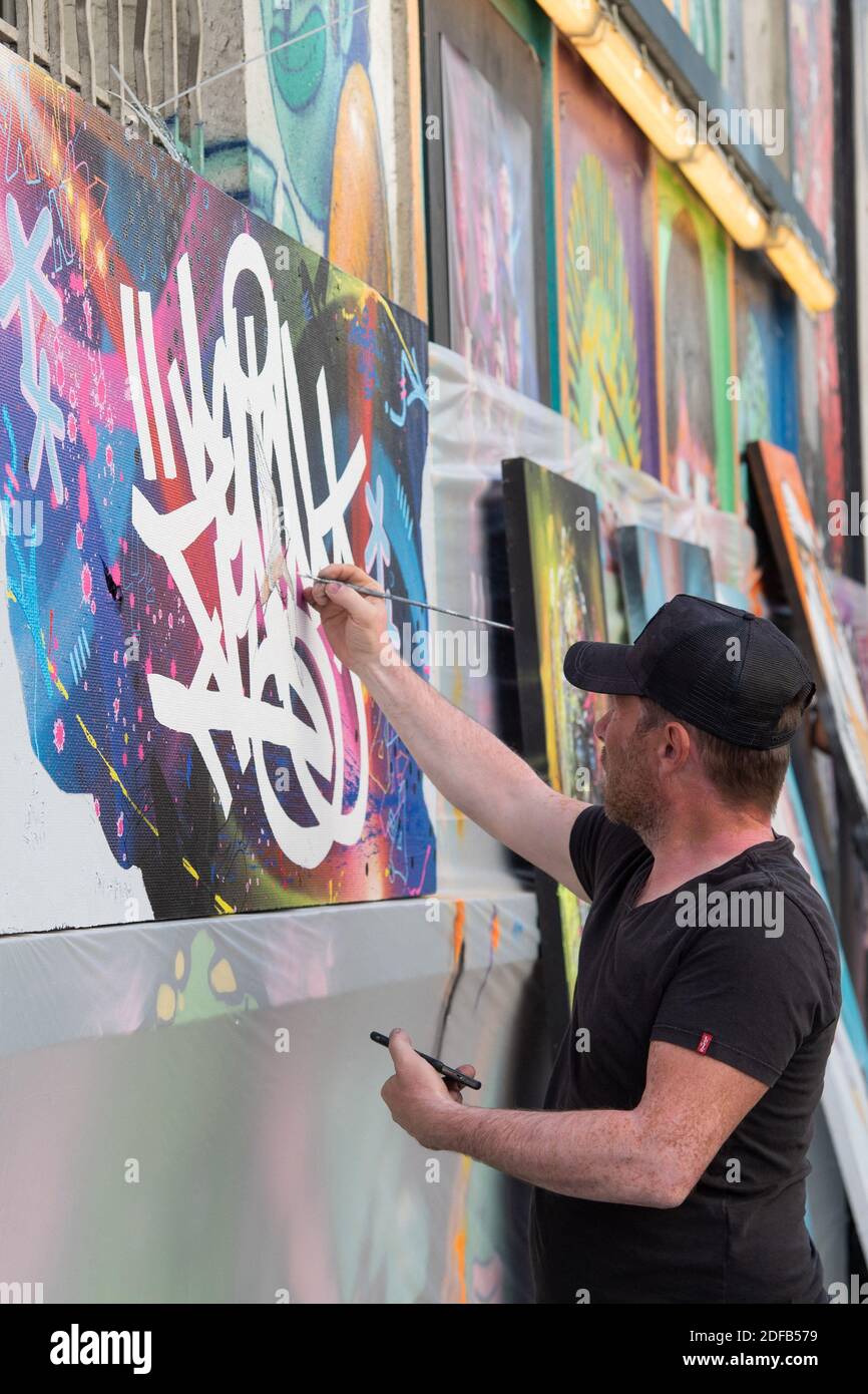 Street artist Zenoy is seen as a street art performance takes place to ...