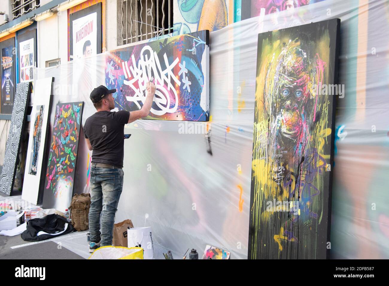 Street artist Zenoy is seen as a street art performance takes place to ...