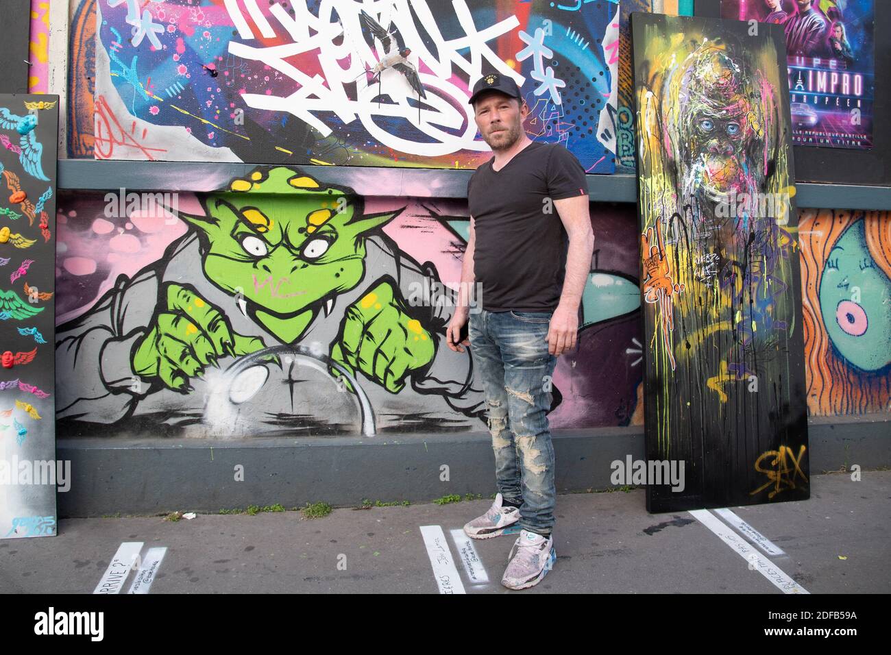 Street artist Zenoy is seen as a street art performance takes place to ...