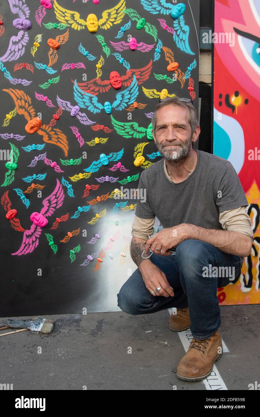 Street artist Gregos is seen as a street art performance takes place to ...