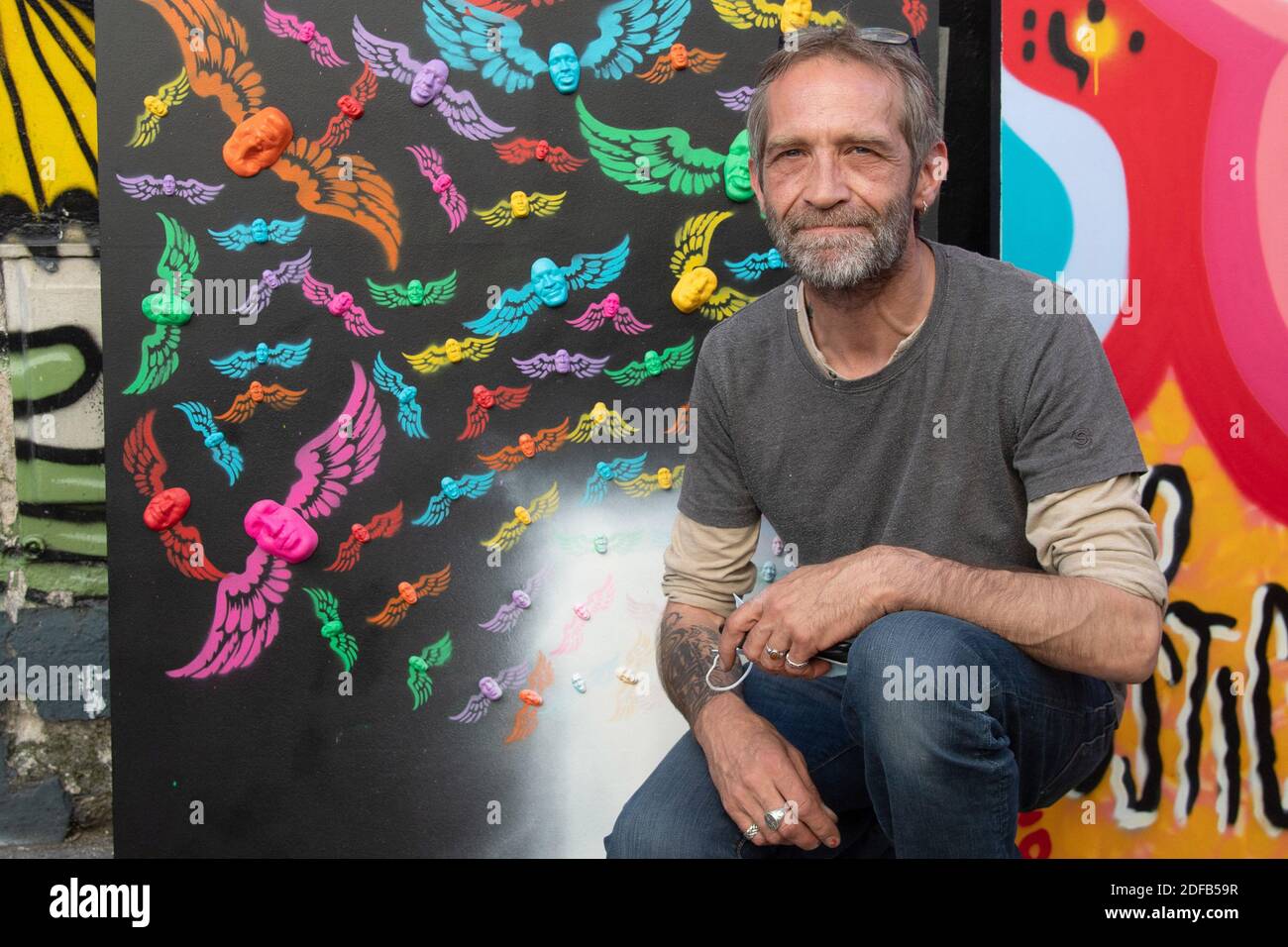 Street artist Gregos is seen as a street art performance takes place to ...